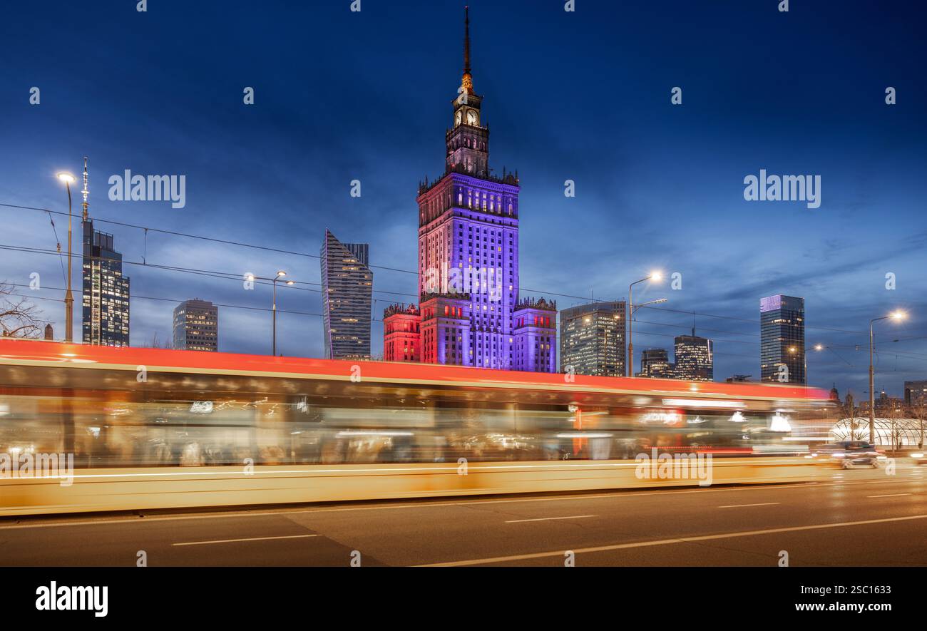 Warsaw Palace of Culture glows in red, white, and blue against the ...