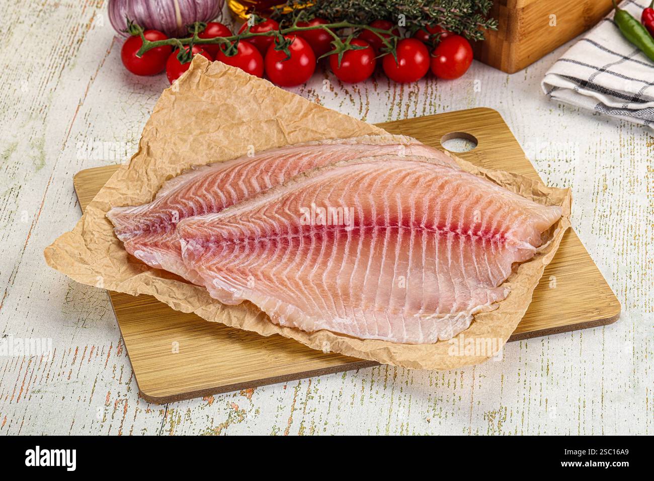 Raw Tilapia fish fillet slice uncooked Stock Photo - Alamy