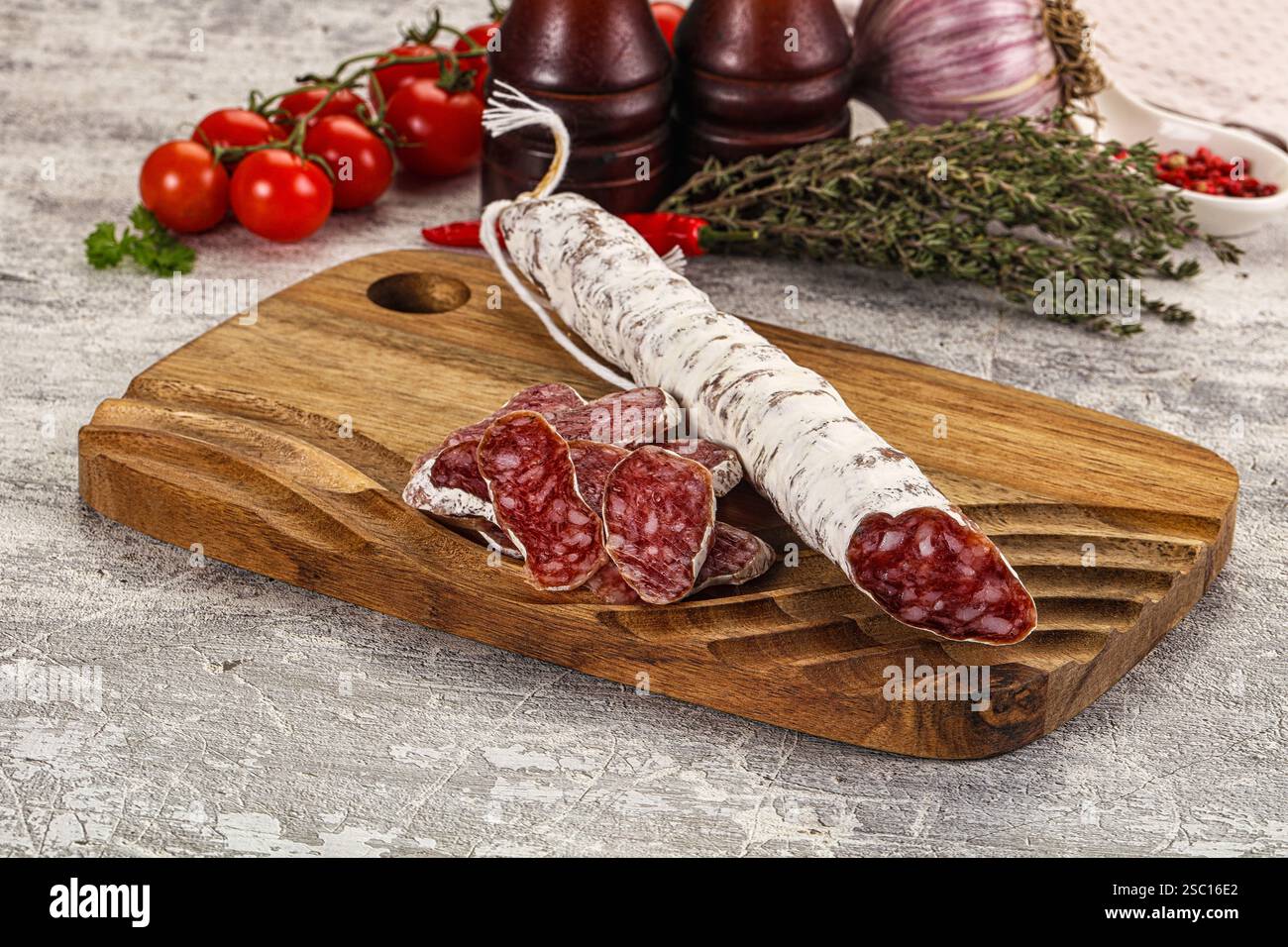 Spanish dry Fuet sausages snack with slices heap Stock Photo - Alamy
