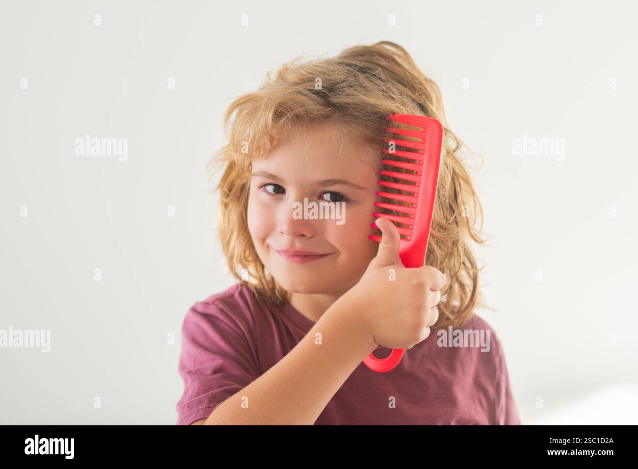 Funny child hairstyle. Kid brushing tangled hair. Funny kids haircut ...