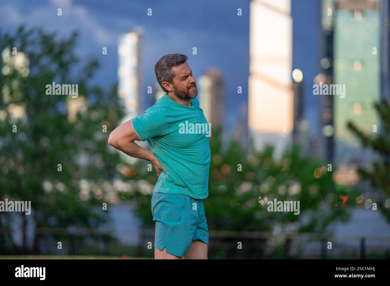 Mature sport man feeling back pain. Trouble with sore muscles. Sports ...