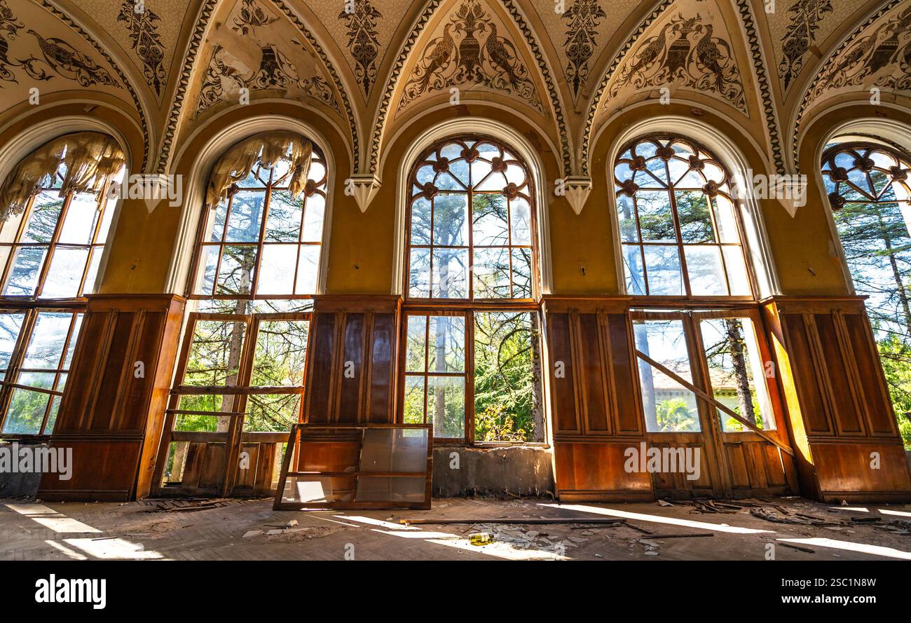 Abandoned historical hall with ornate vaulted ceiling, large arched ...