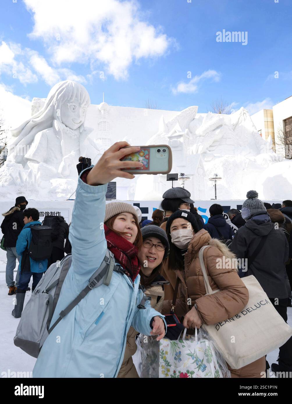 Visitors enjoy snow statues and sculptures at the Sapporo Snow Festival ...