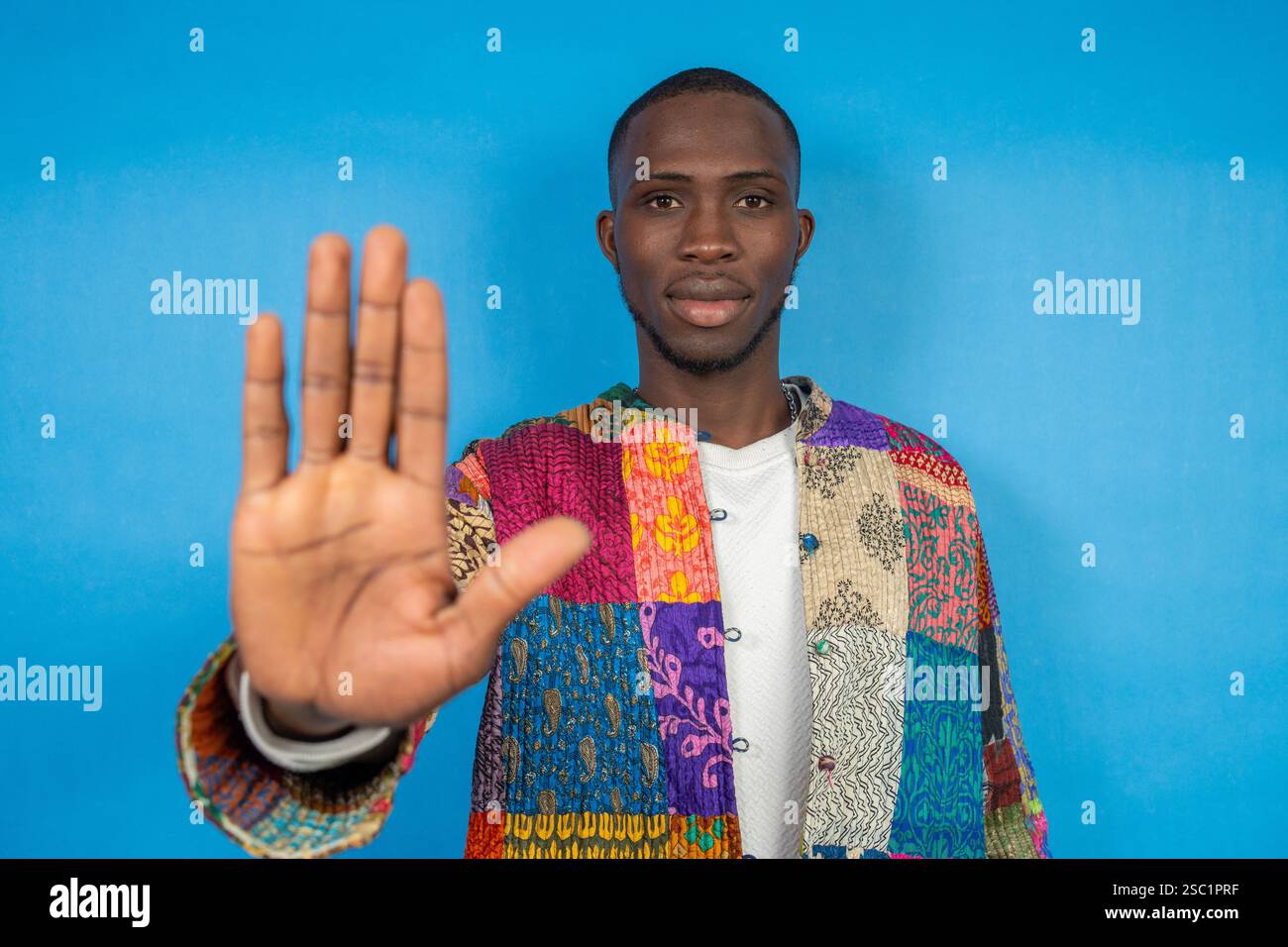 Confident young man making stop gesture with hand, expressing refusal ...