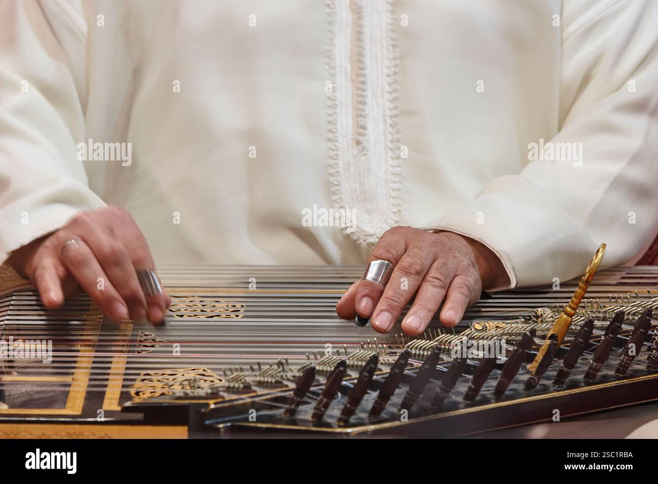 Traditional moroccan musician with wooden string instrument. Qanun ...