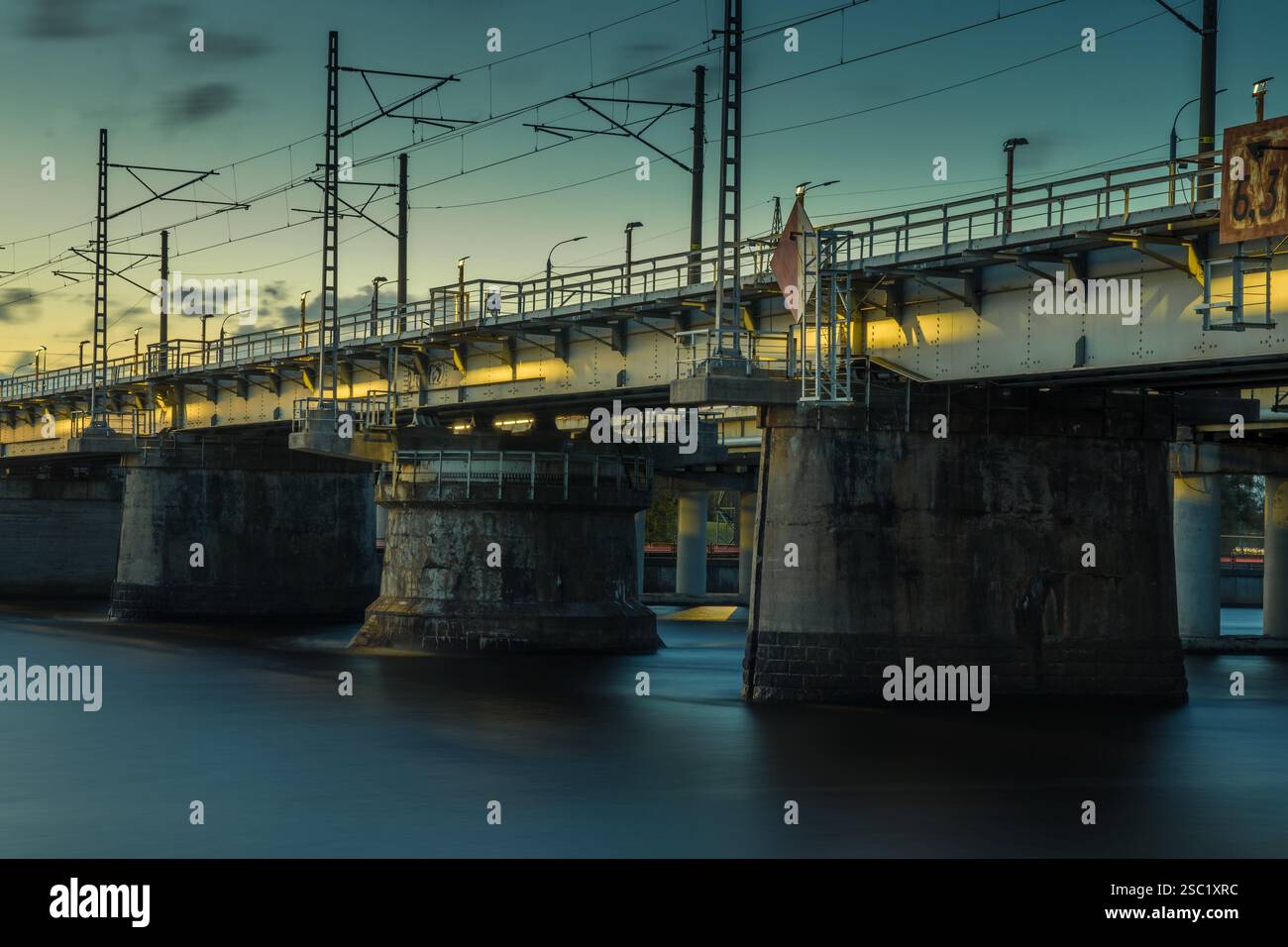 Bridge spanning a river or canal at twilight. Architectural shot ...