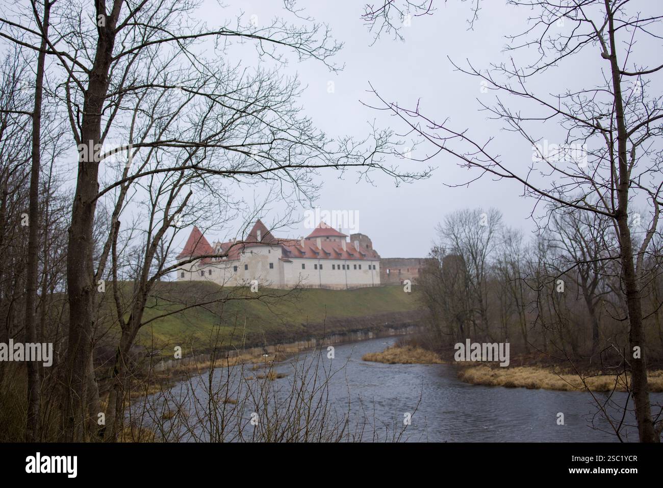 Bauska Castle in Latvia, with its medieval towers and red tiled roof ...
