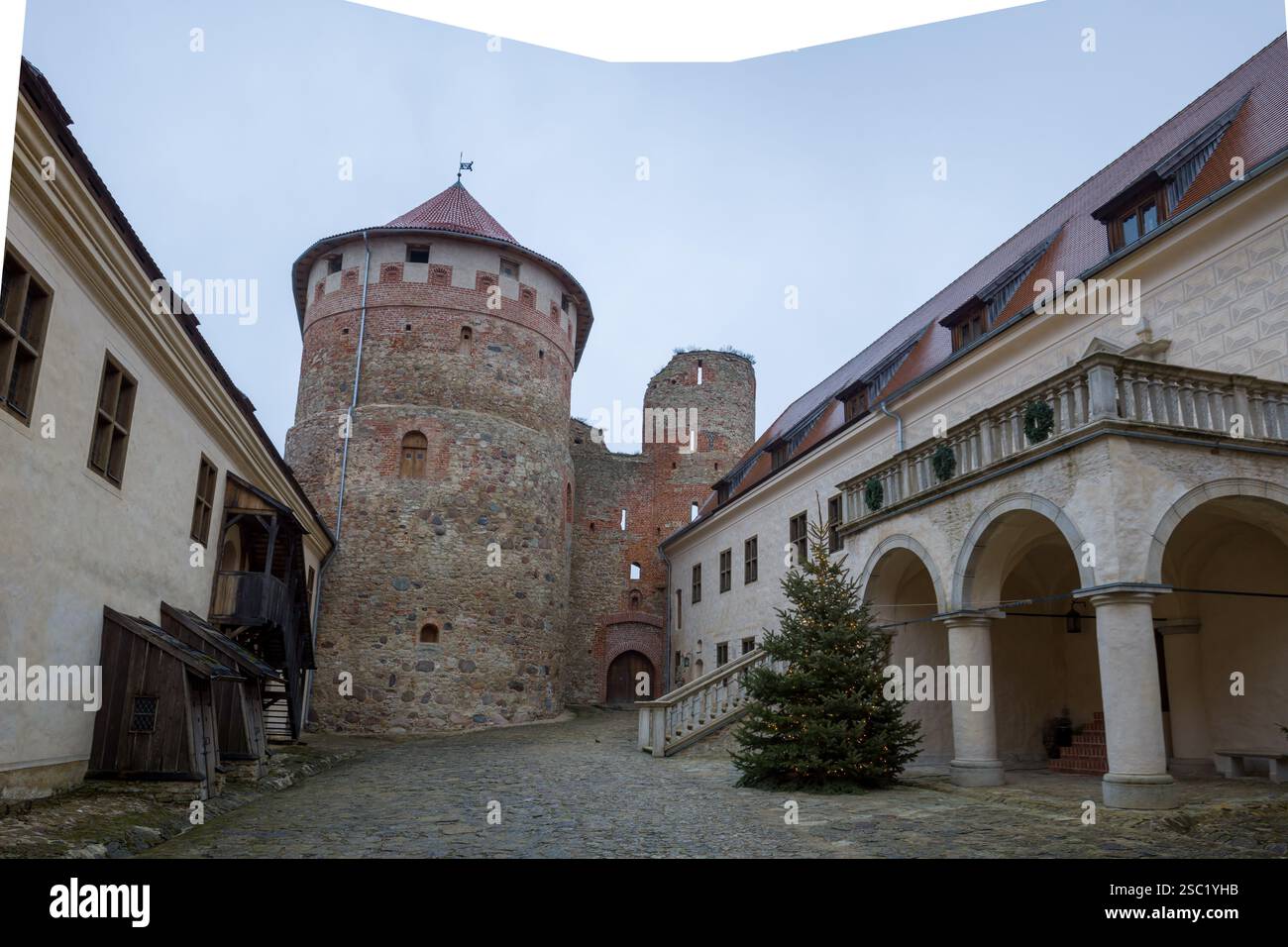 Bauska Castle in Latvia, with its medieval towers and red tiled roof ...