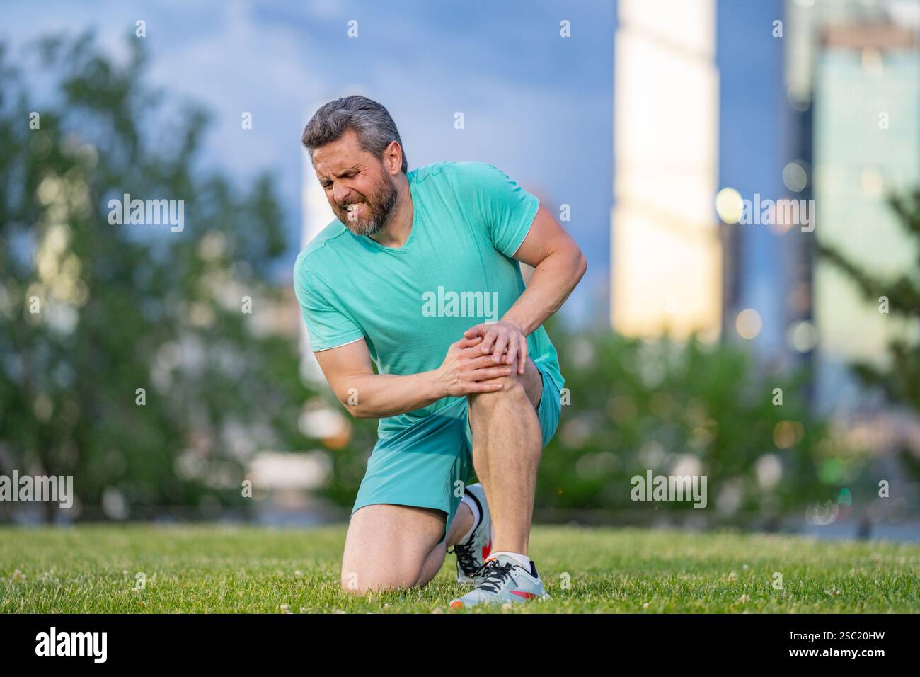 Pain knee after sport. Leg hurt during jogging. Injured man holding ...