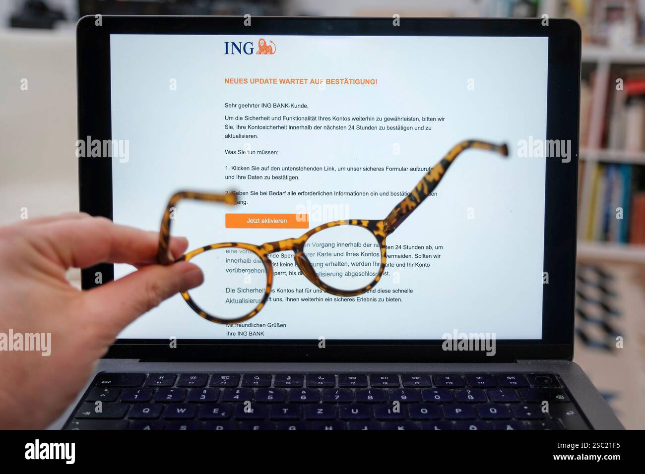 Fraudulent phishing email on a laptop reporting an alleged update to an ...