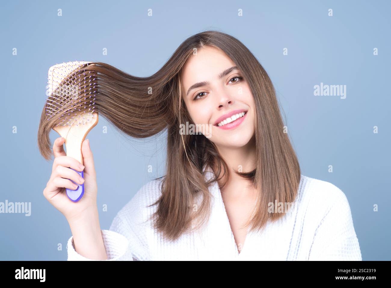 Woman combing her hair. Cares about a healthy and clean hair. Beauty ...