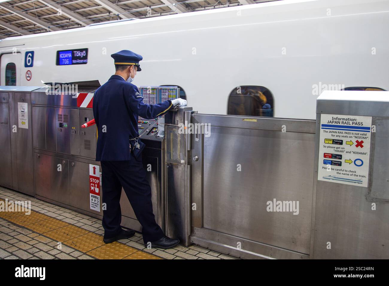 Station staff on the platform of the Shinkansen train at Shin-Osaka ...
