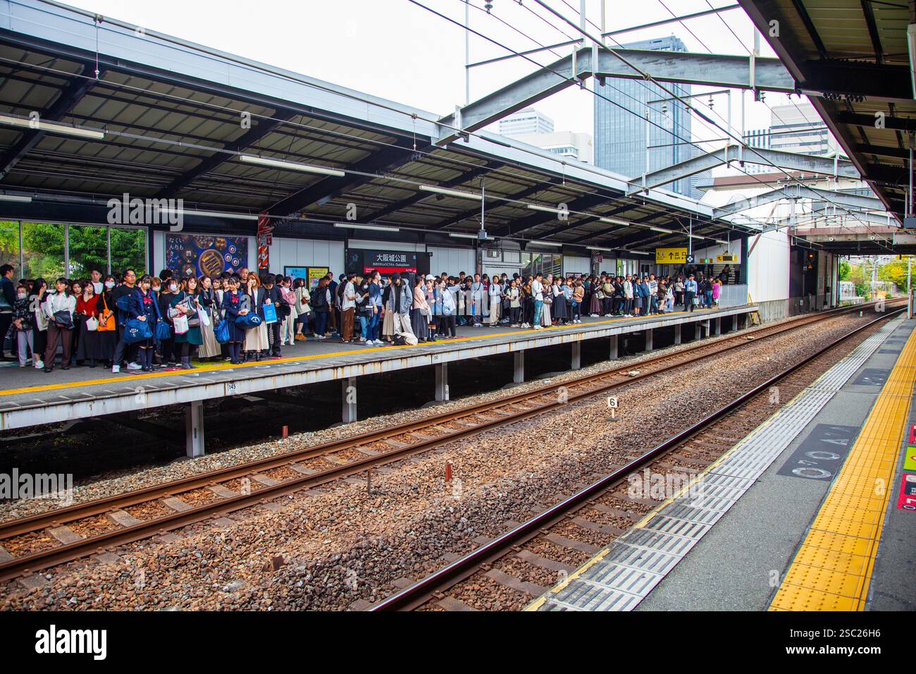 Osakajo-koen station platform in Osaka, Japan with many passengers waiting for a train to arrive ...