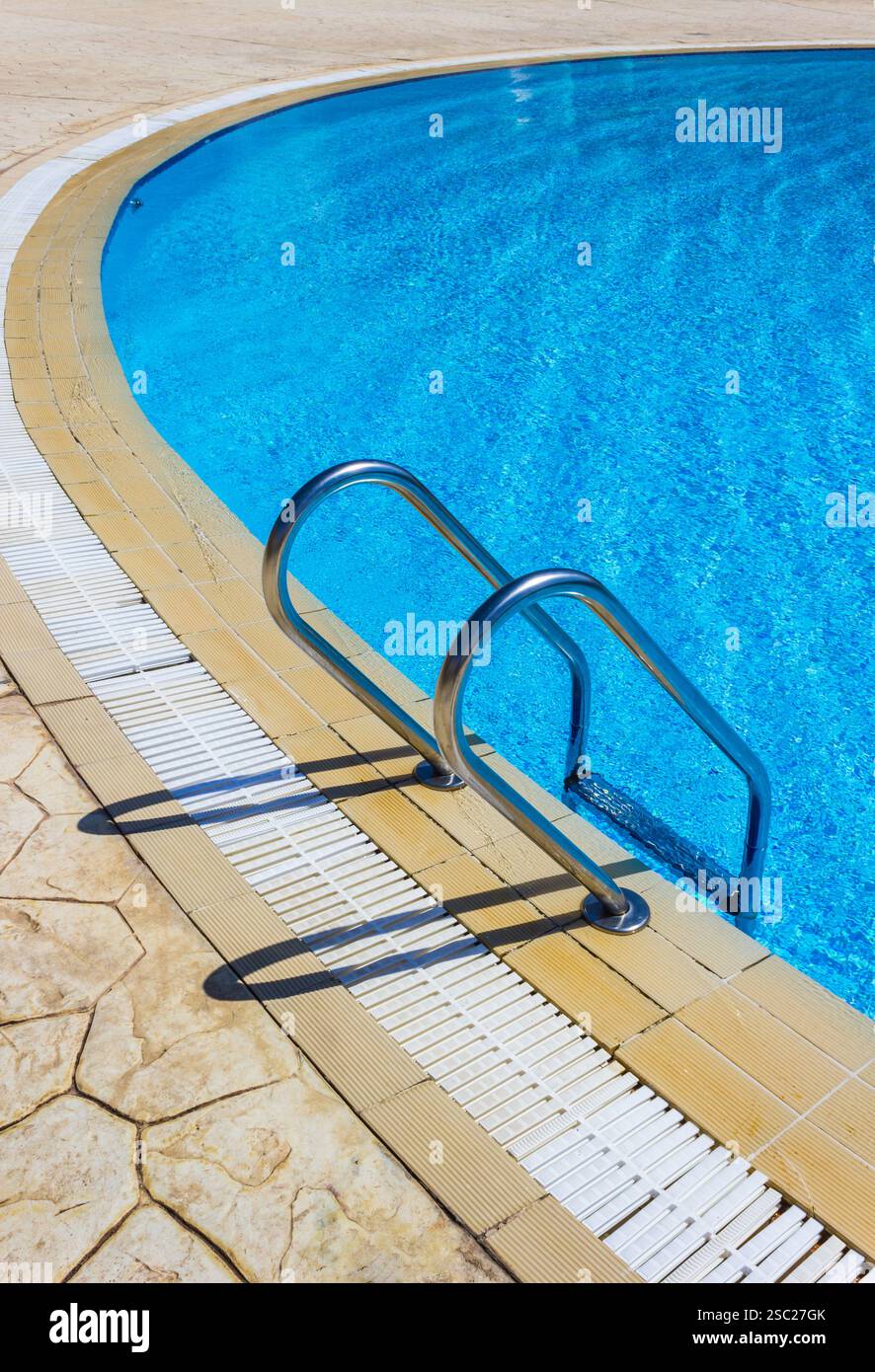 Grab bars ladder in the blue swimming pool Stock Photo - Alamy