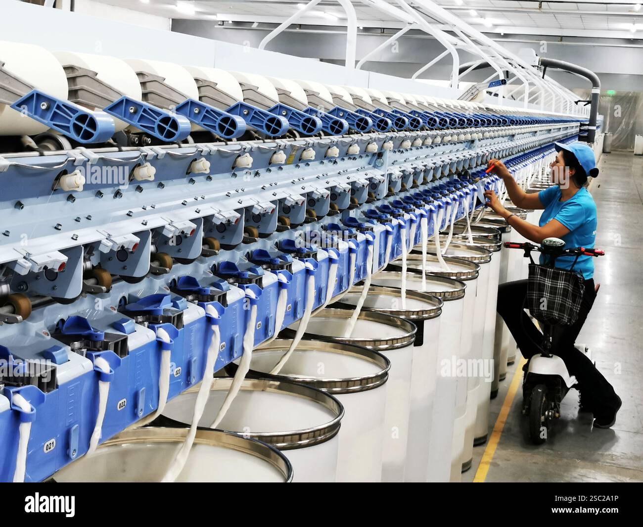 A worker works at a textile workshop of a textile company in Aksu ...