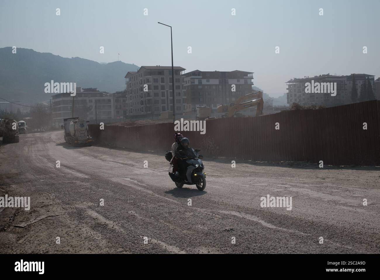 A couple on a motorcycle through a construction site. On February 6 ...