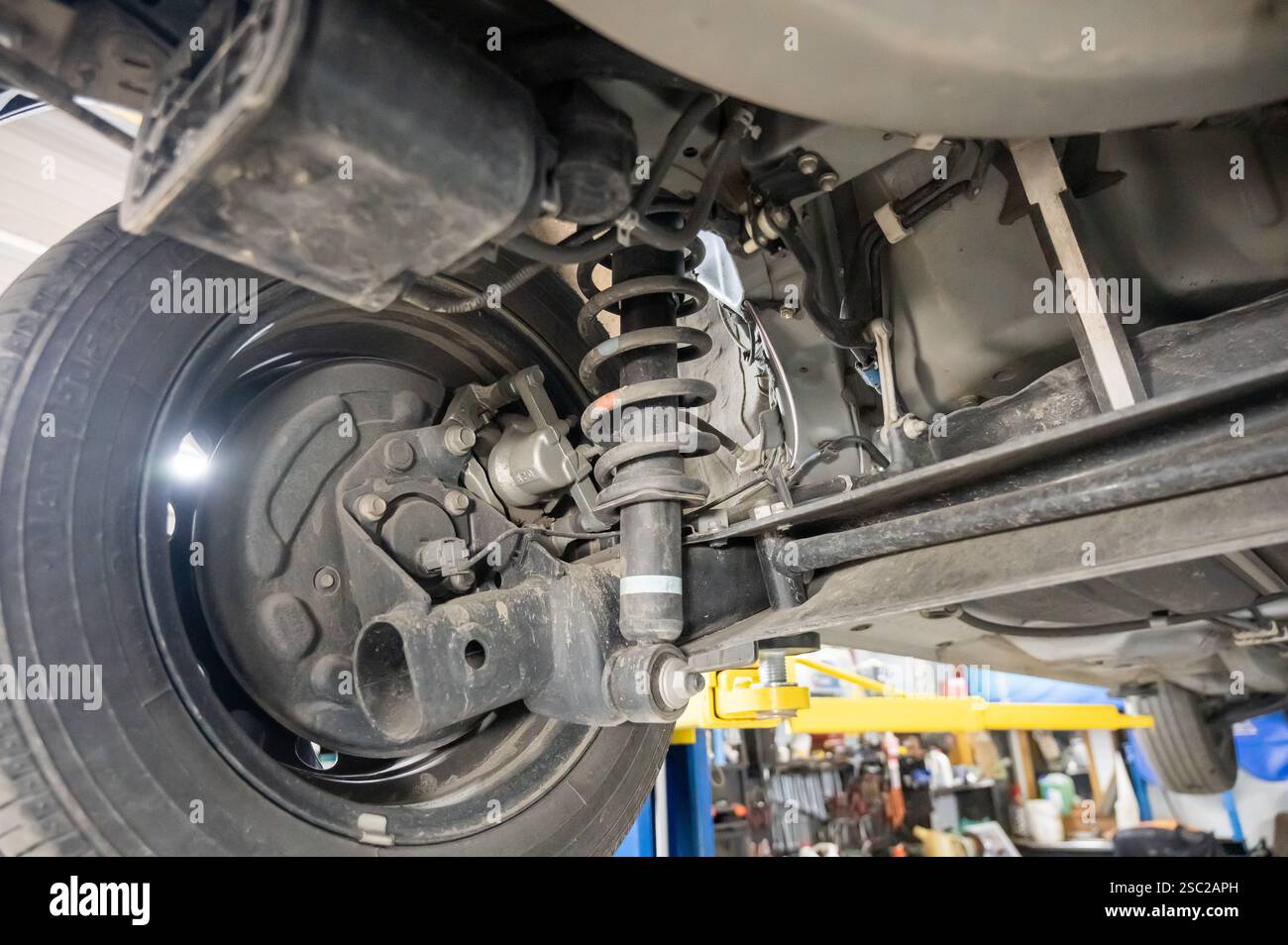 Shock spring under a car tire Stock Photo - Alamy
