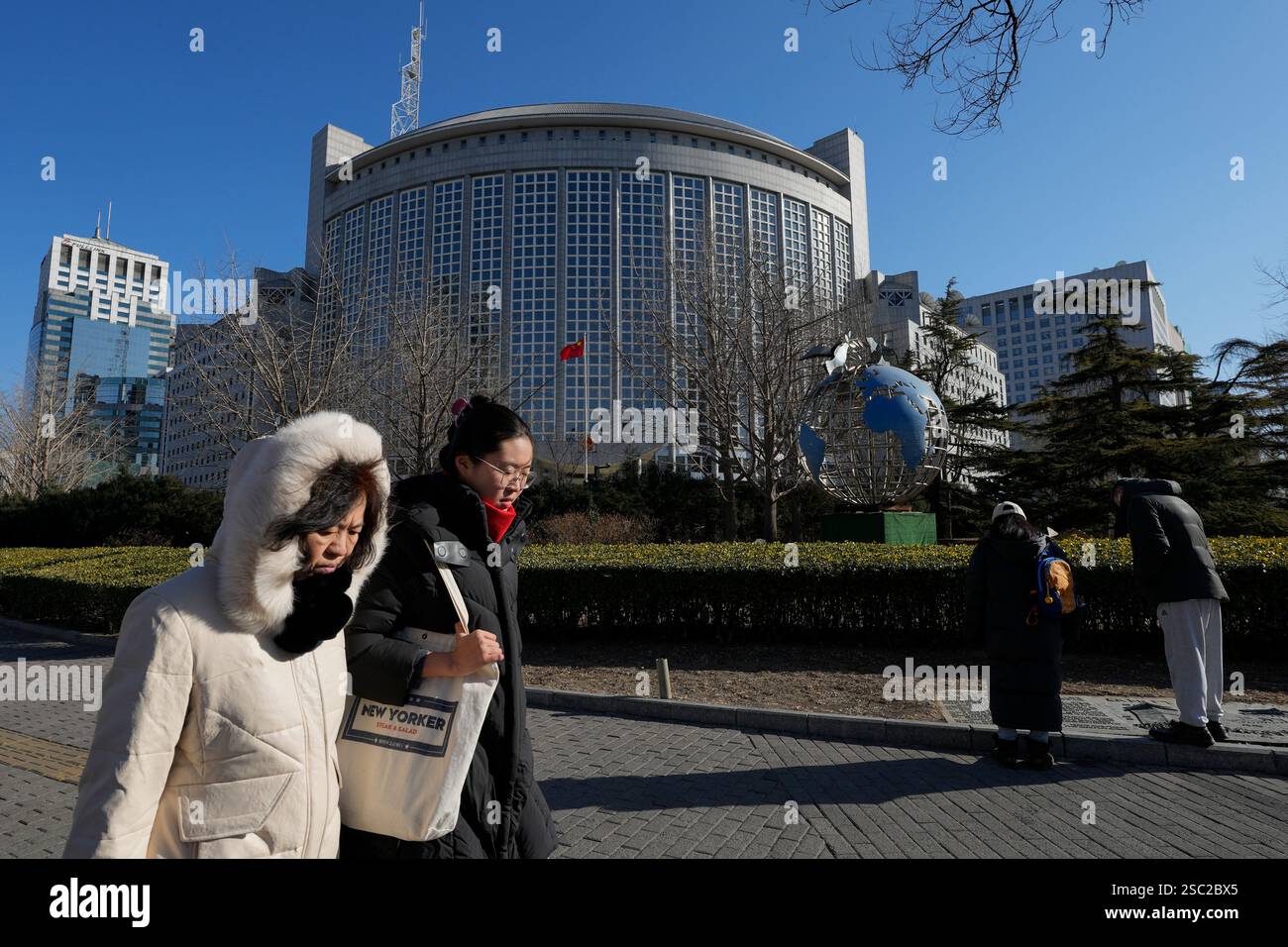People walk by the Ministry of Foreign Affairs office in Beijing ...