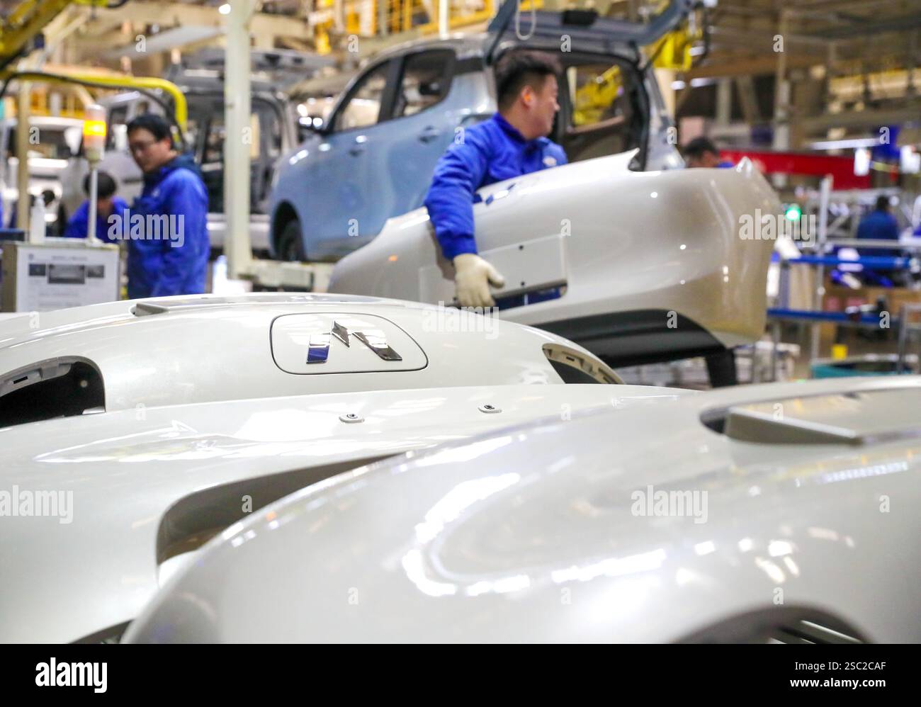 QINGDAO, CHINA - FEBRUARY 5, 2025 - A worker carries parts at the ...