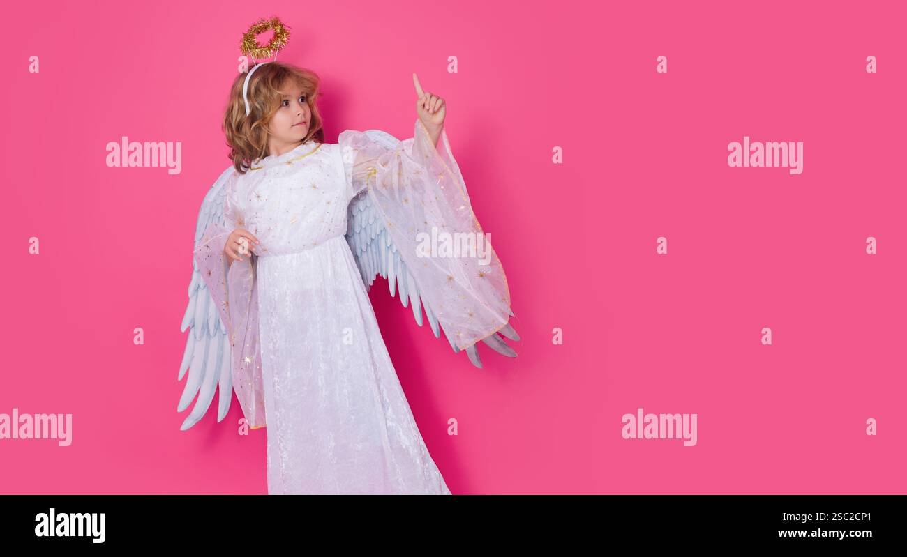 Child angel pointing finger, point gesture. Little angel. Portrait of ...