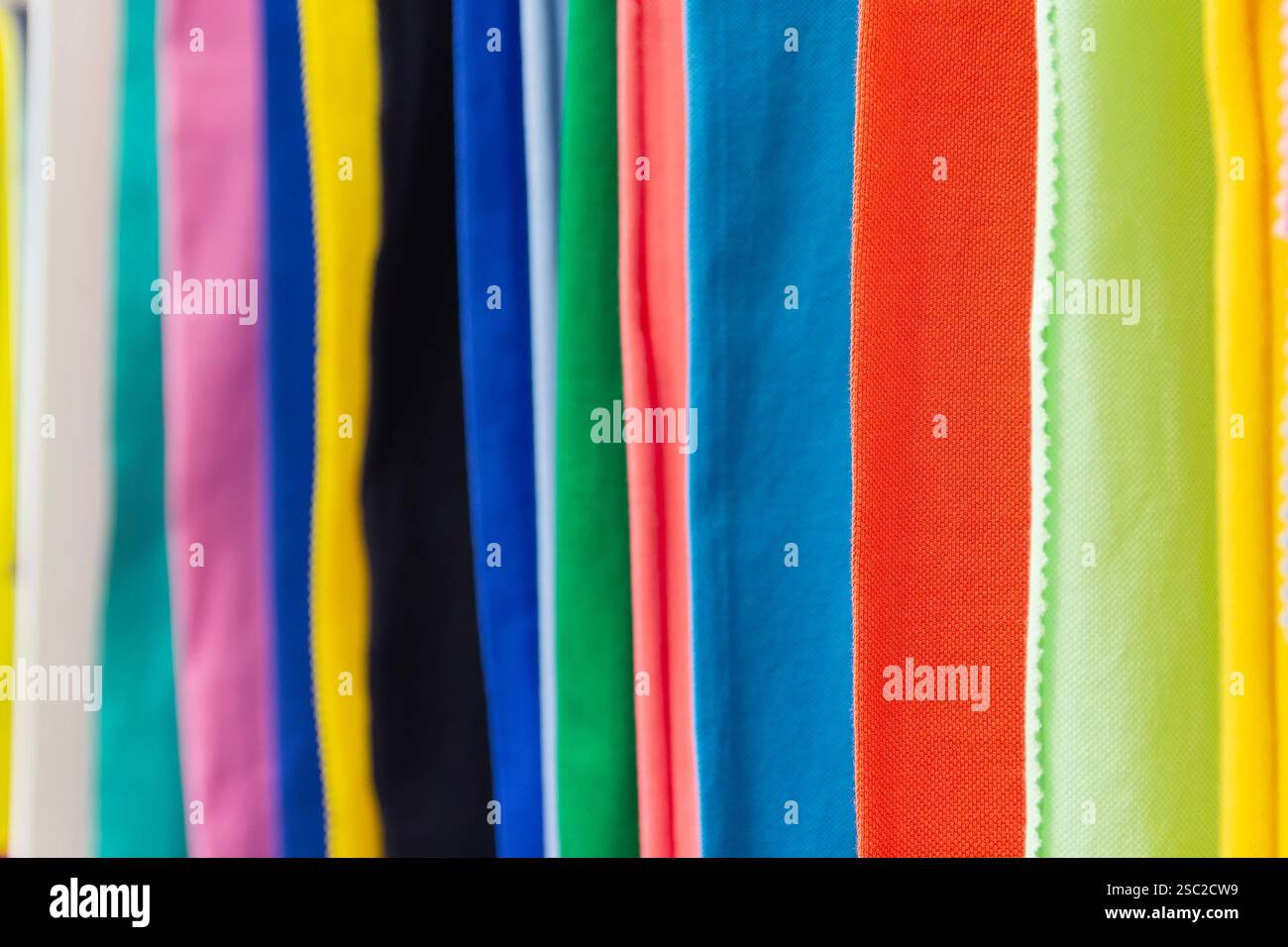 Colorful fabrics hang in a row. Textile industry Stock Photo - Alamy