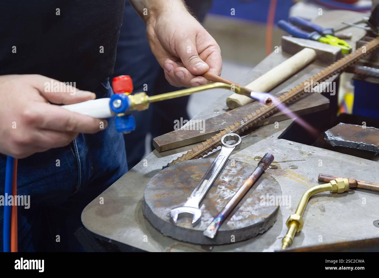 Heat treatment of copper pipe using a gas torch. Industry Stock Photo ...