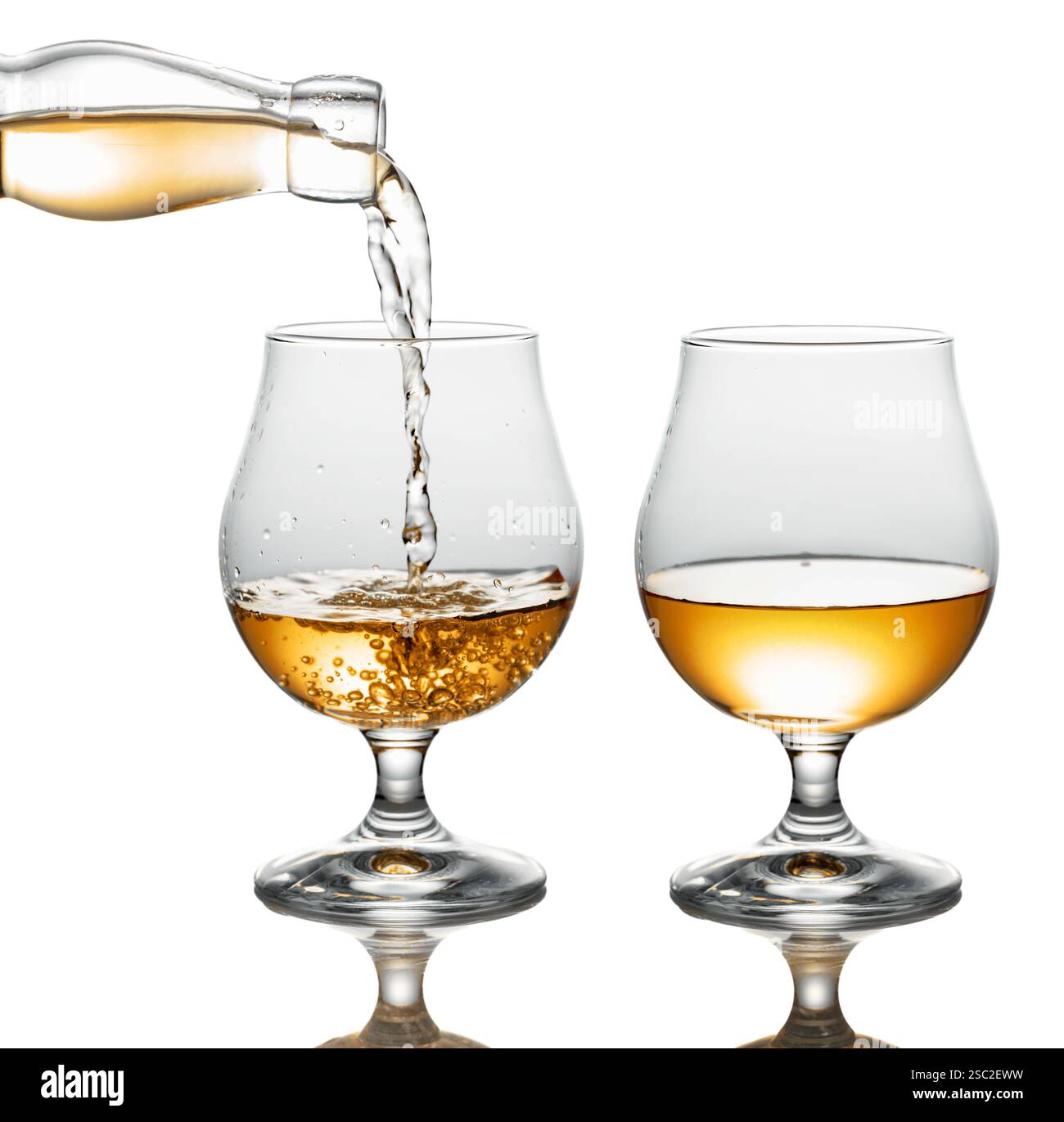 Brandy pouring into a glass. Isolated on a white background Stock Photo ...