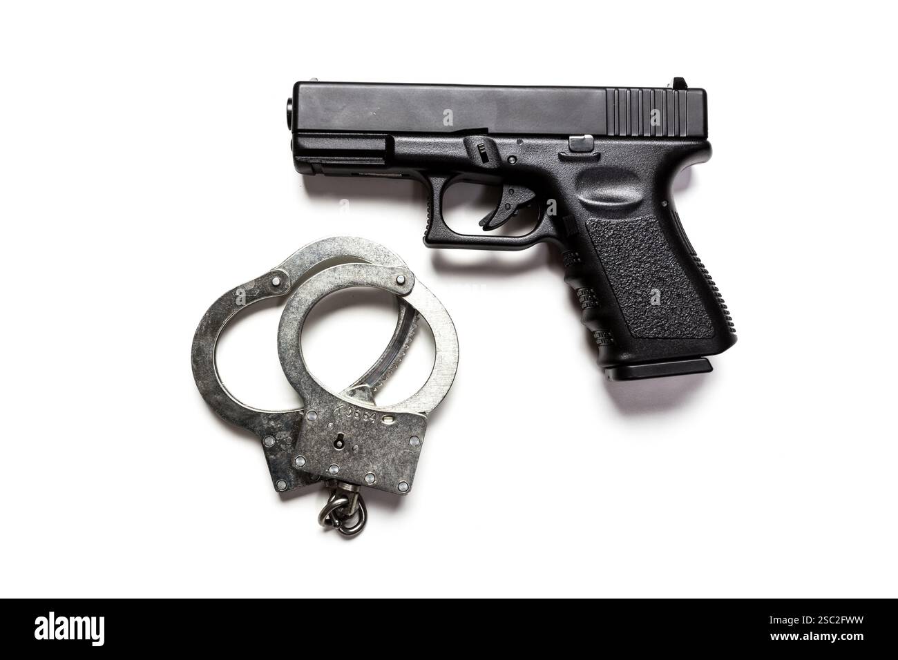 gun and handcuffs on white background Stock Photo - Alamy