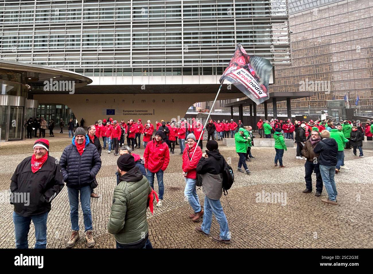 Members of trade unions carry a flag and march during a rally to call ...