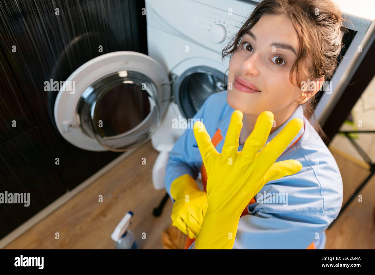 Housekeeper cleaning the kitchen with eco-friendly cleaning products ...