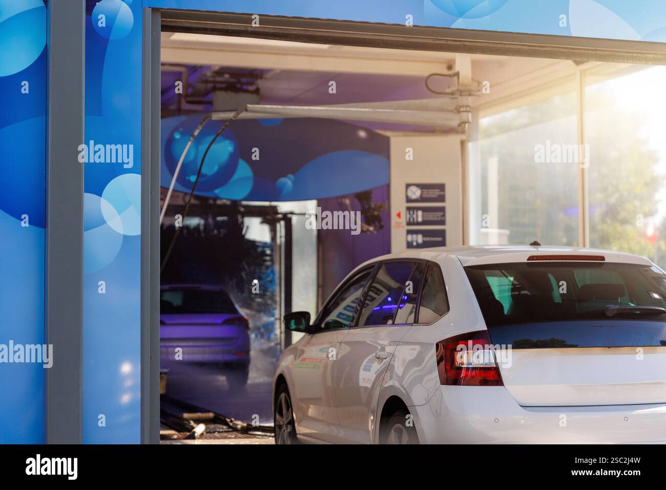 Automatic self-service tunnel car wash machine. Vehicle queue carwash station modern cleaning ...