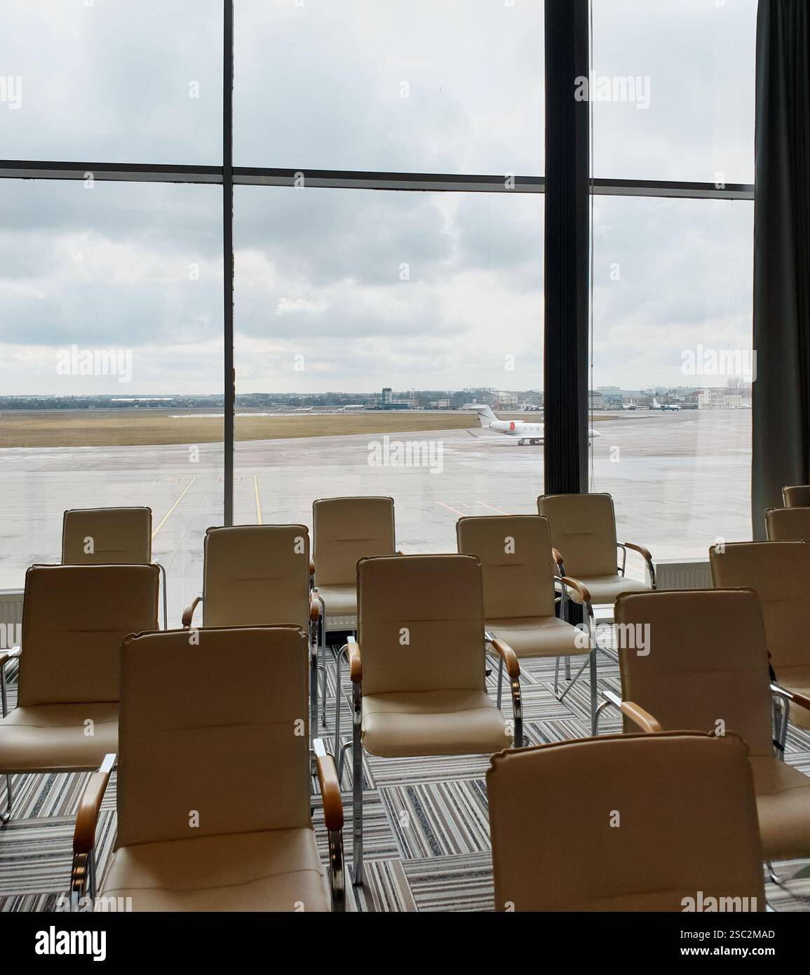 Empty chairs in VIP terminal of regional airport. Waiting lounge with a ...