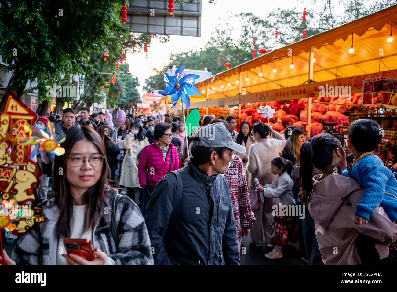 People flock to the a flower market in Guangzhou City, south China's ...