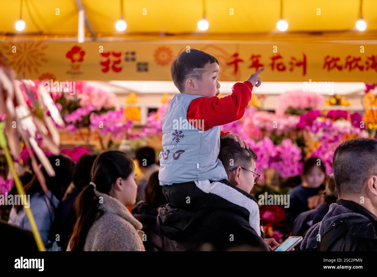 People flock to the a flower market in Guangzhou City, south China's ...