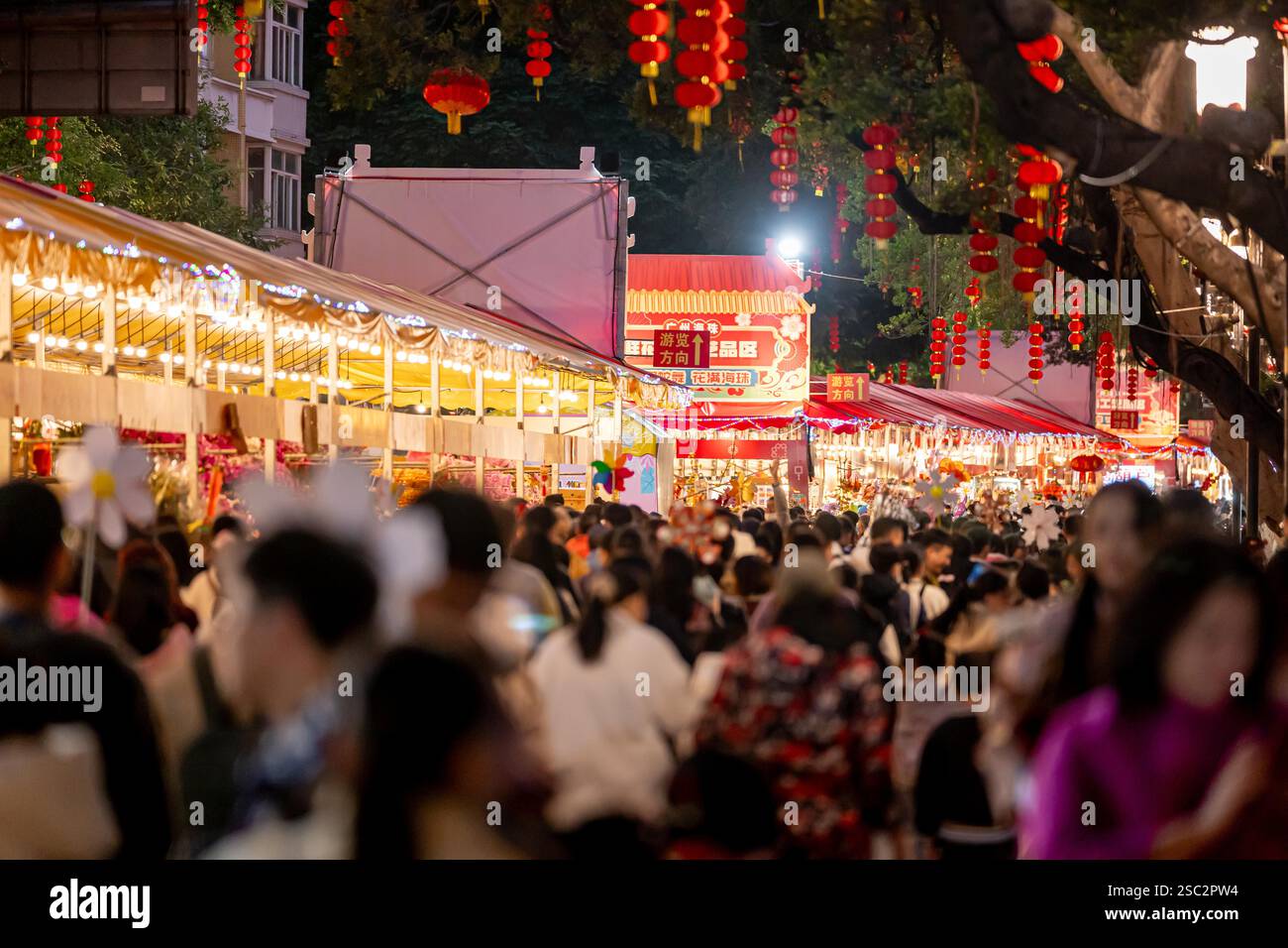 People flock to the a flower market in Guangzhou City, south China's ...