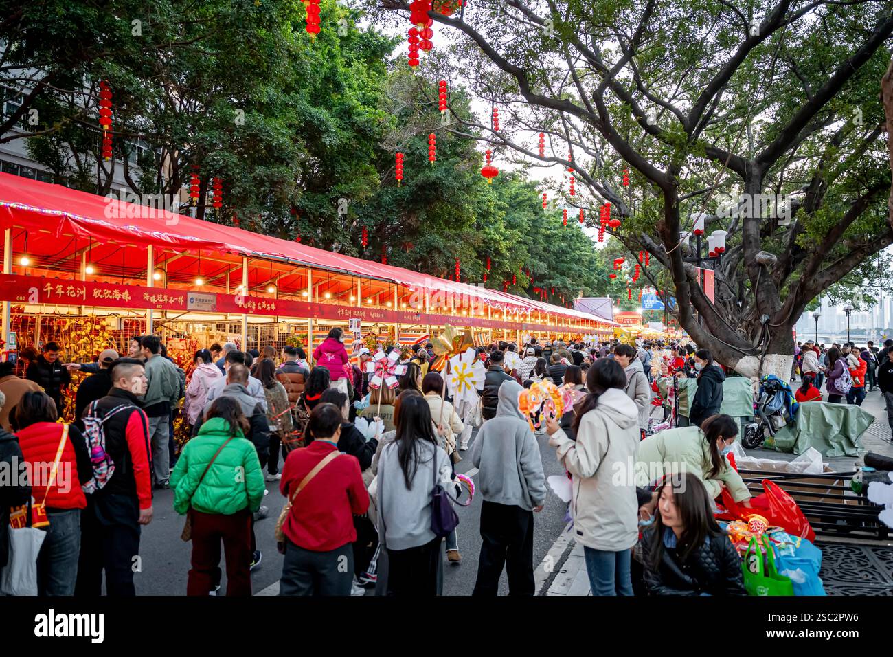People flock to the a flower market in Guangzhou City, south China's ...