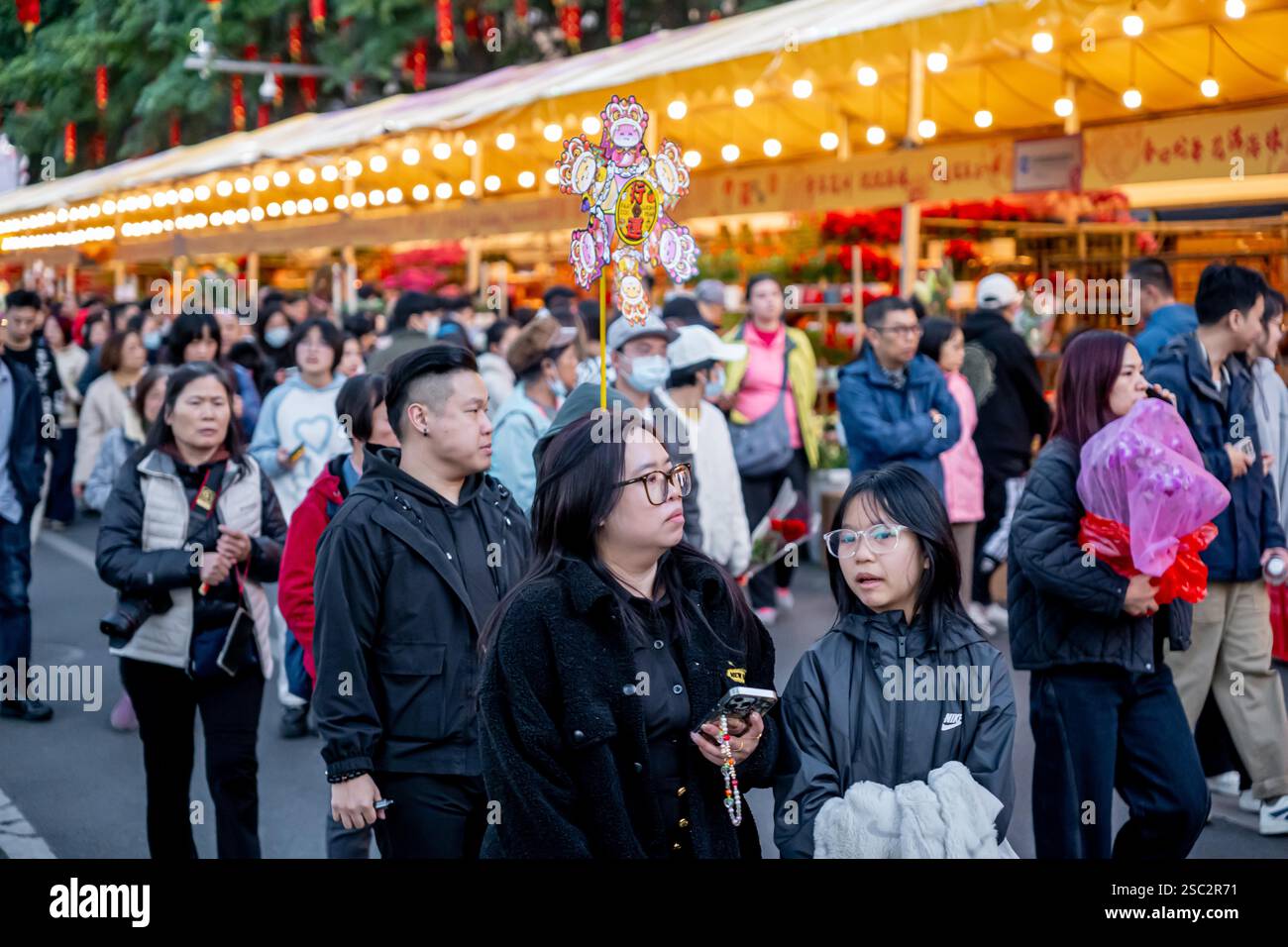People flock to the a flower market in Guangzhou City, south China's ...