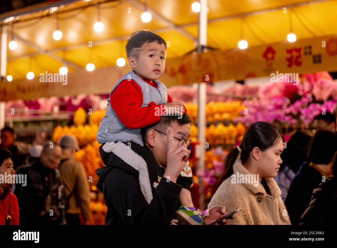People flock to the a flower market in Guangzhou City, south China's ...