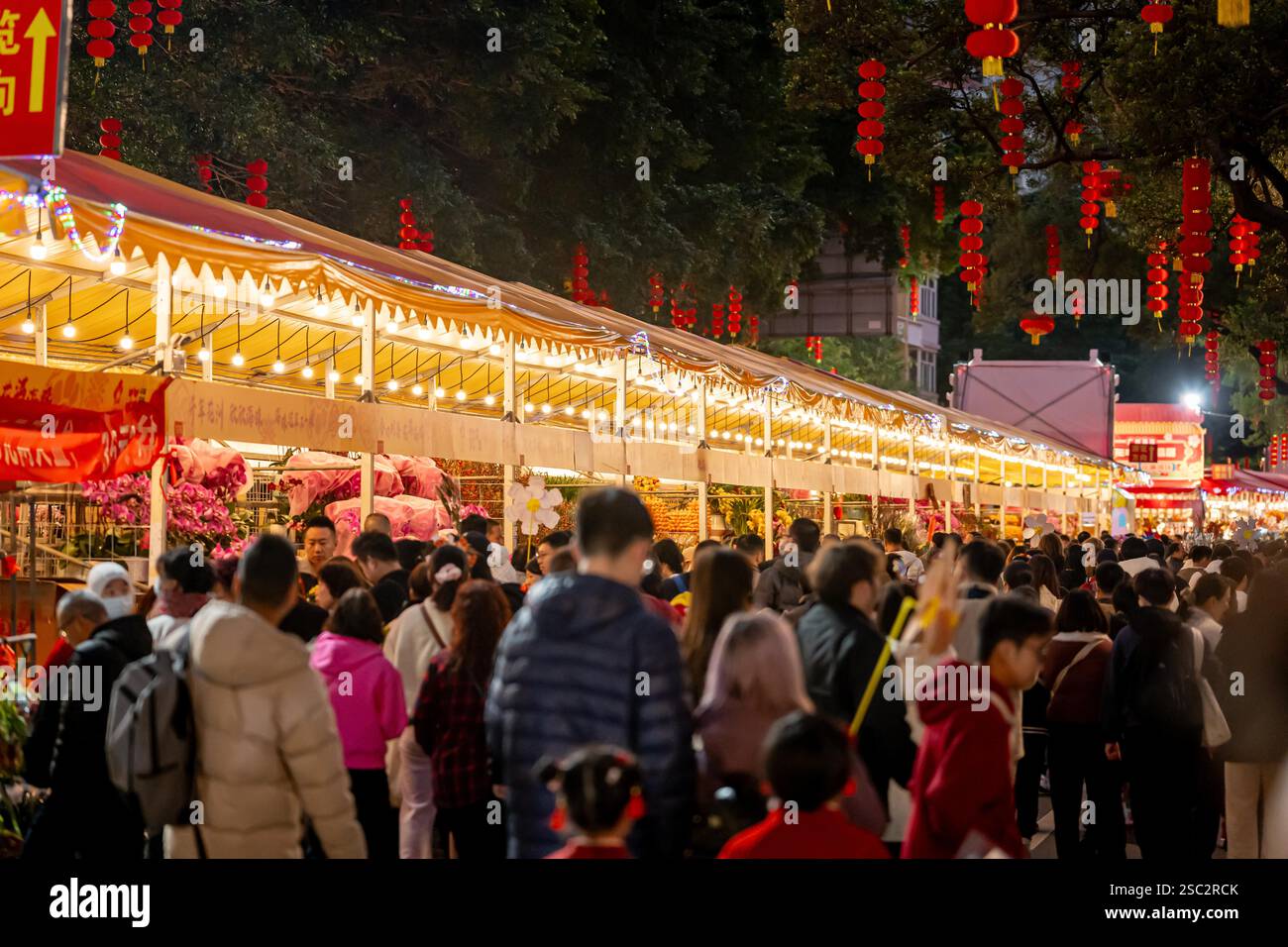 People flock to the a flower market in Guangzhou City, south China's ...