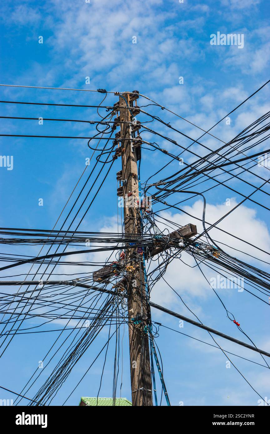 Intertwining of many electrical wires on poles Stock Photo - Alamy