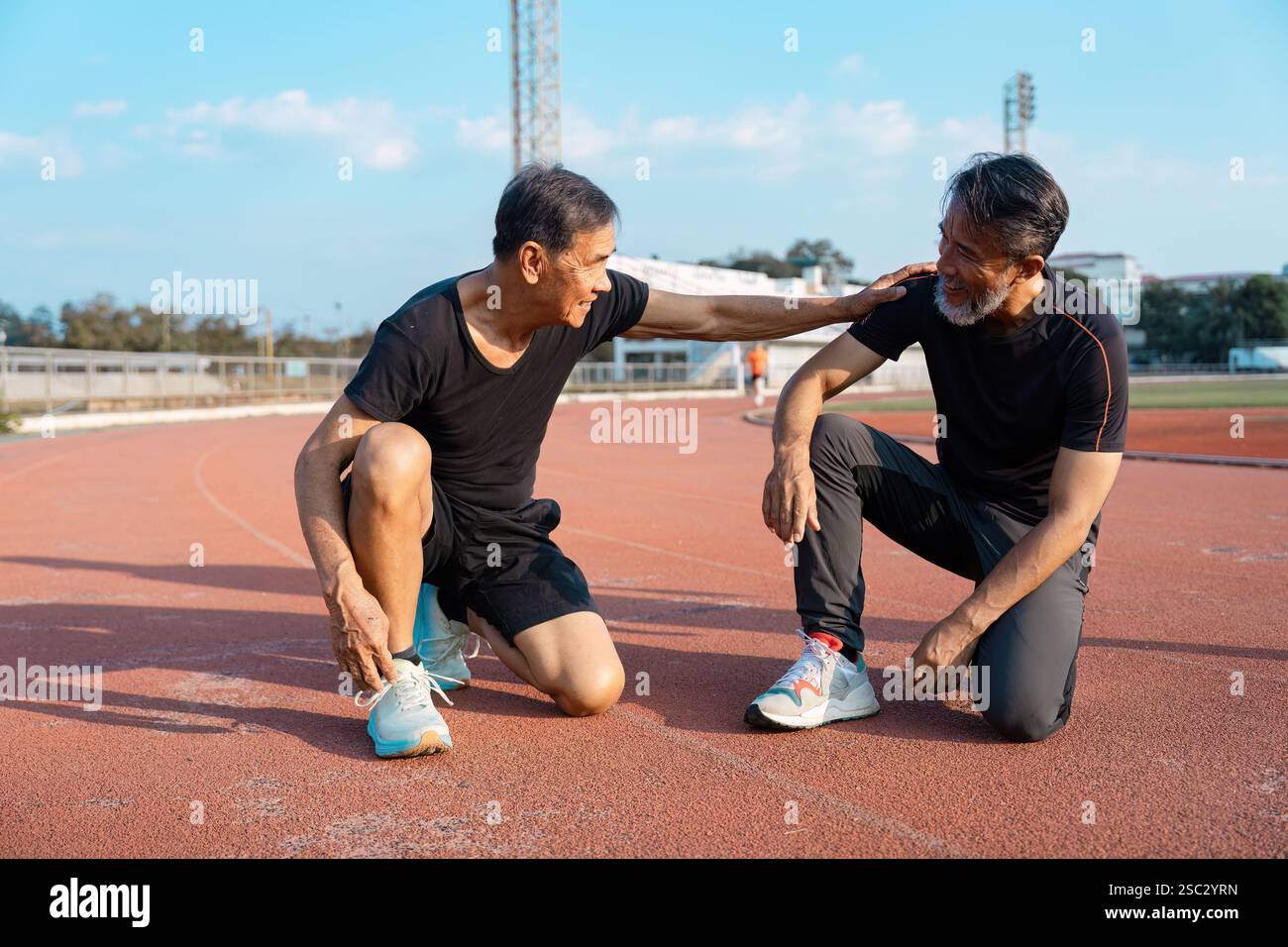 Supportive elderly men encouraging each other after a workout on a ...