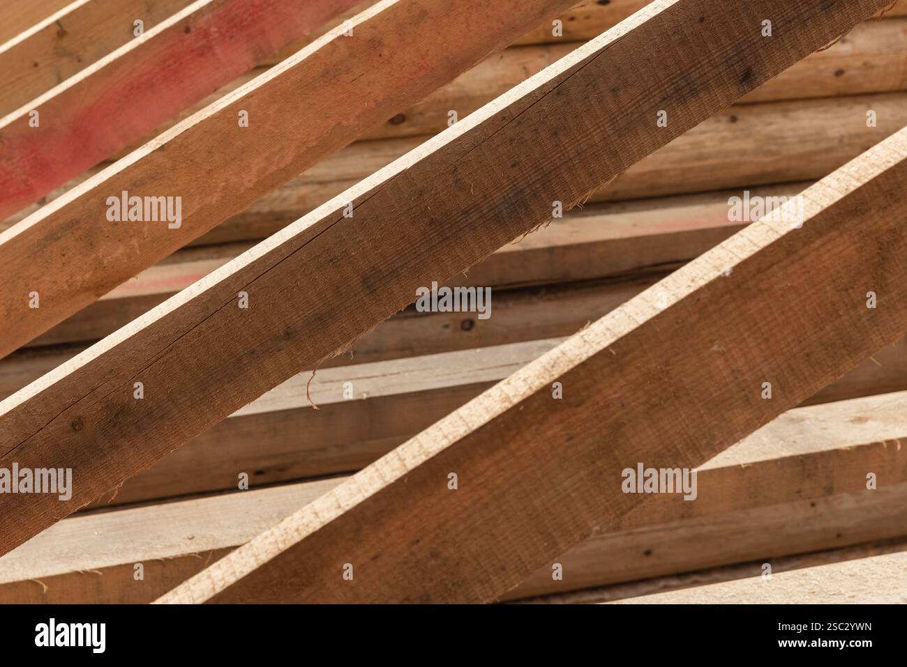 Wooden house roof is under construction. Rafters and beams background ...