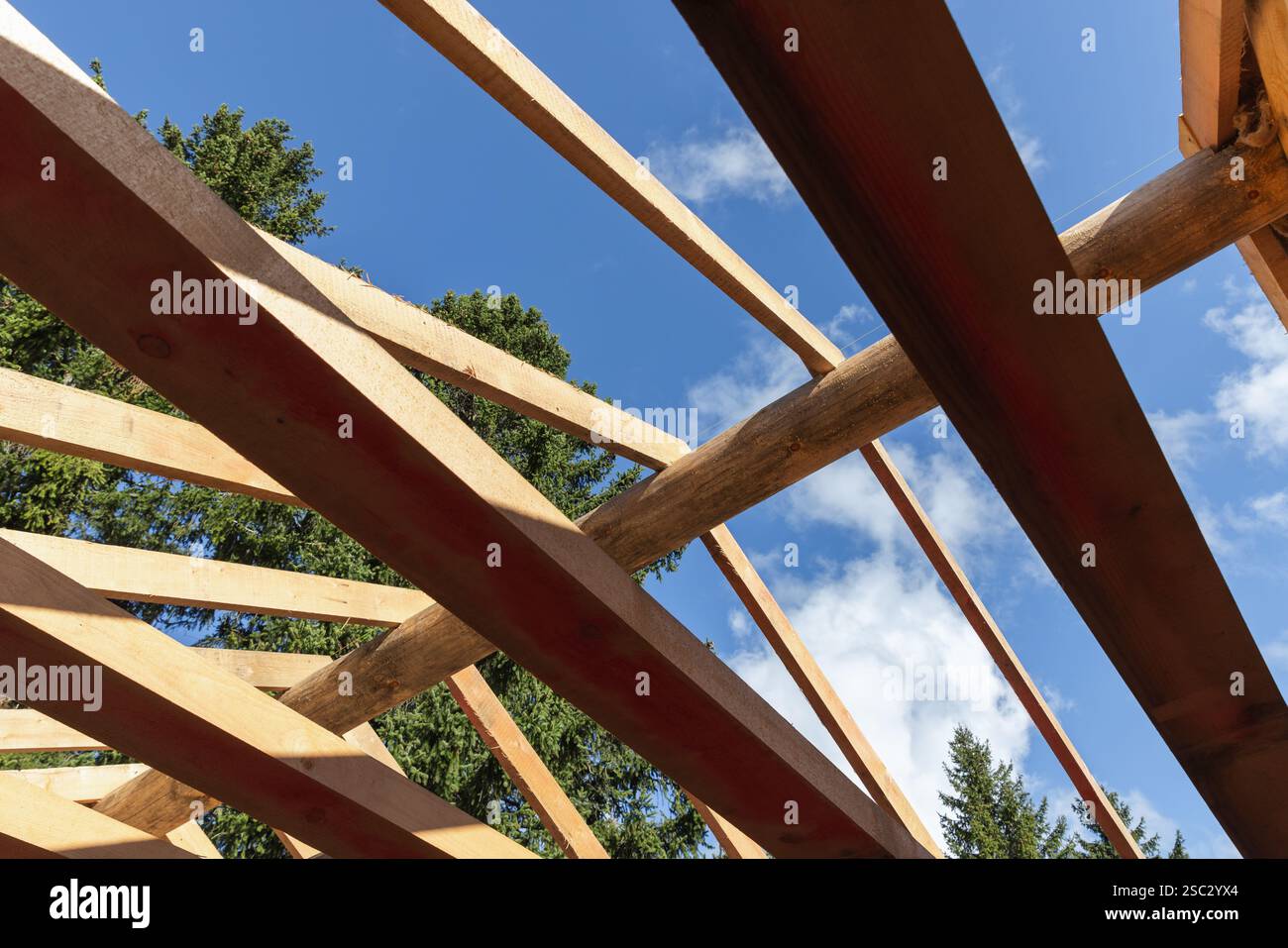 Unfinished roof carcass of a log house under construction. Uncolored ...