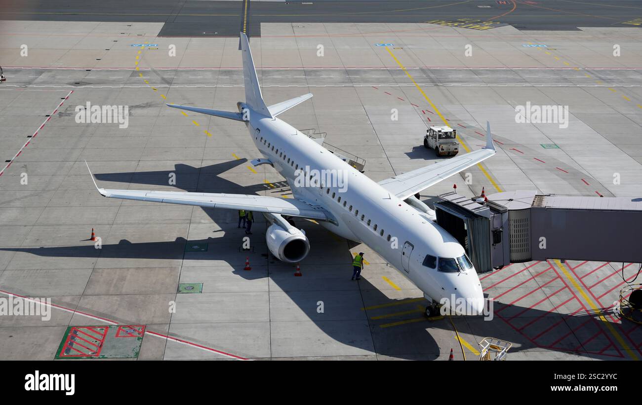 A all white Embraer 190 aircraft during ground handling at Frankfurt ...