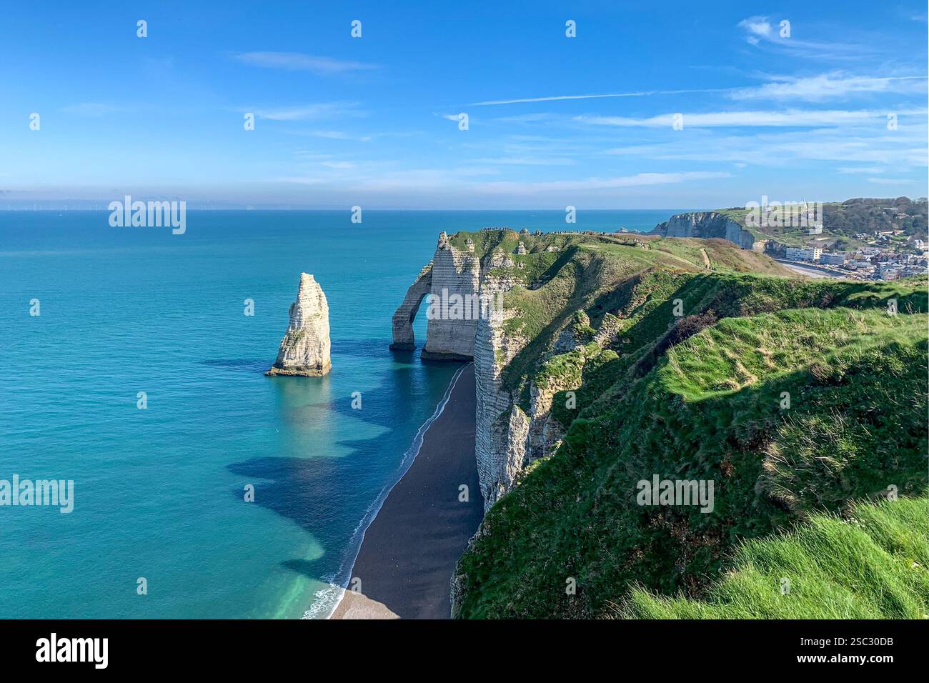 View of the famous rock arch and needle of the cliff of Etretat ...
