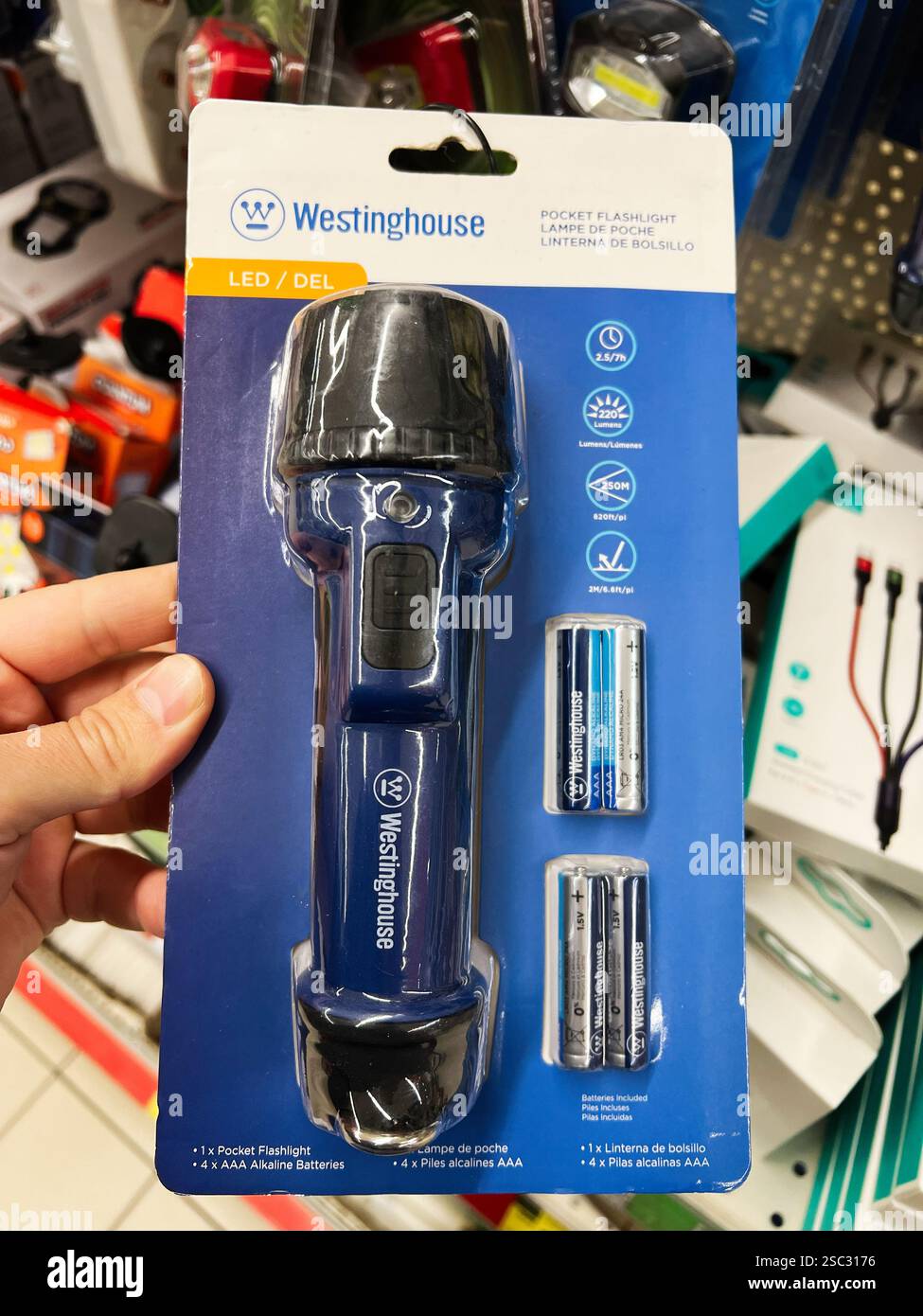 Kyiv, Ukraine - February 04, 2025: Pocket flashlight with batteries packaged for sale in retail ...