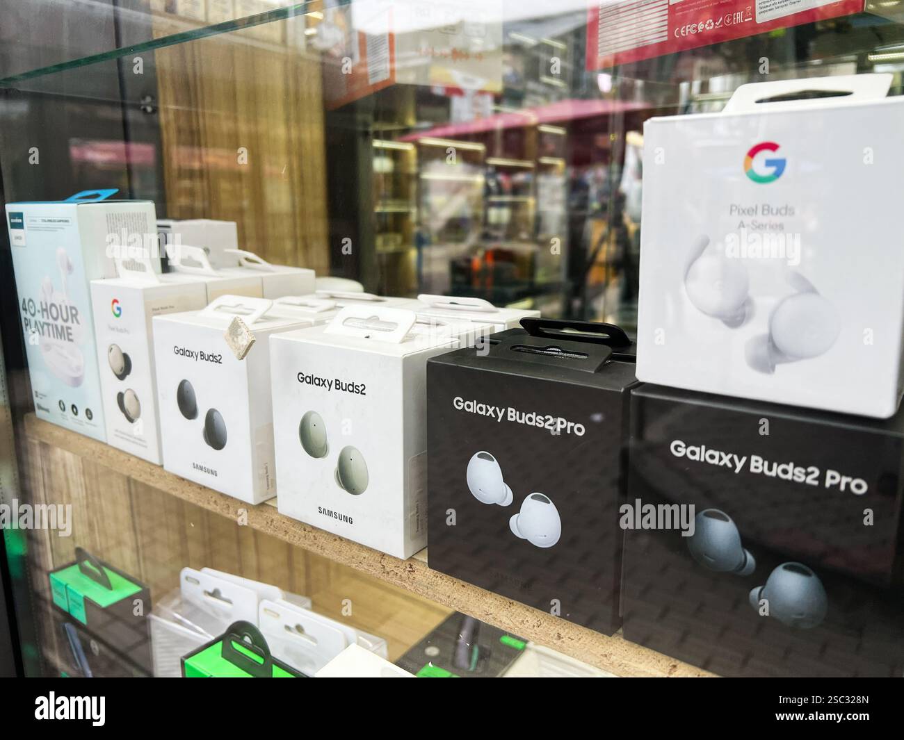 Kyiv, Ukraine - February 04, 2025: Multiple packaged wireless earbuds ...