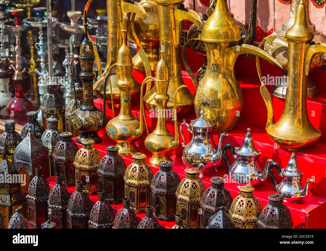 row of shiny traditional coffee pots and lamp at the souq in Dubai ...