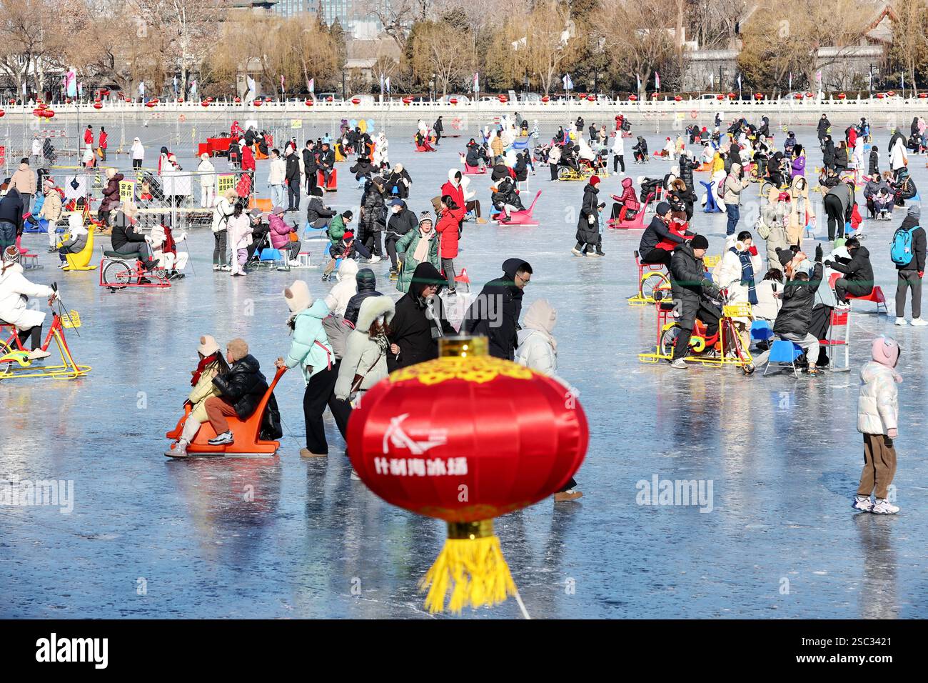 Visitors skate at an outdoor rink at Shichahai in Beijing, China, 28 ...