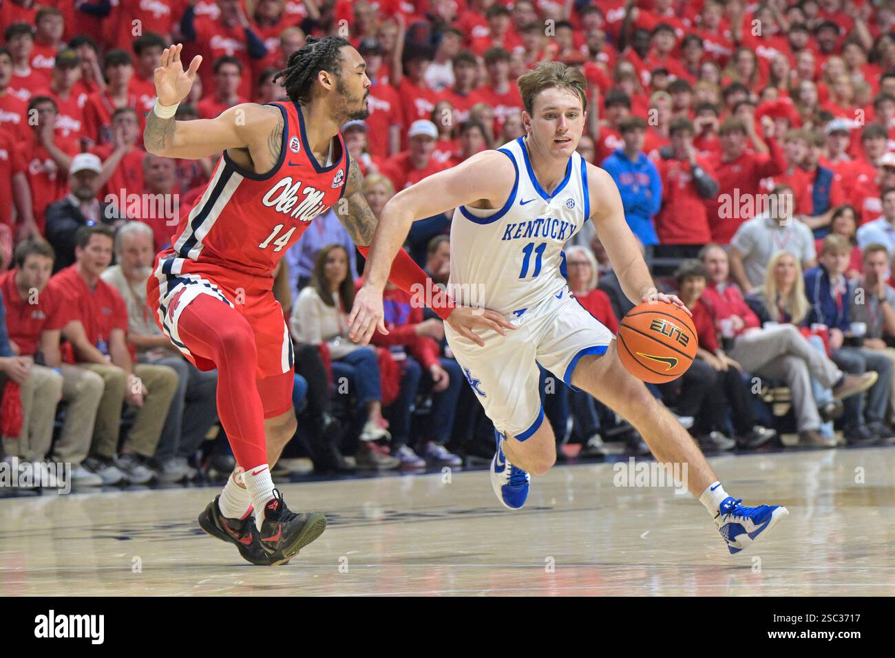 Kentucky guard Travis Perry (11) is defended by Mississippi guard Dre ...